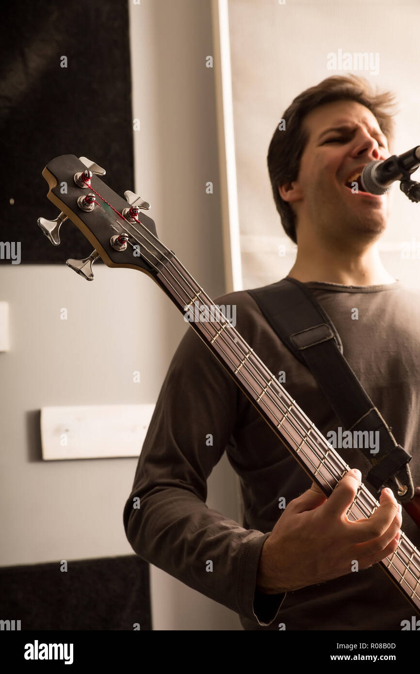 Black and white Portrait of a Rock singer playing bass in the rehearsal ...