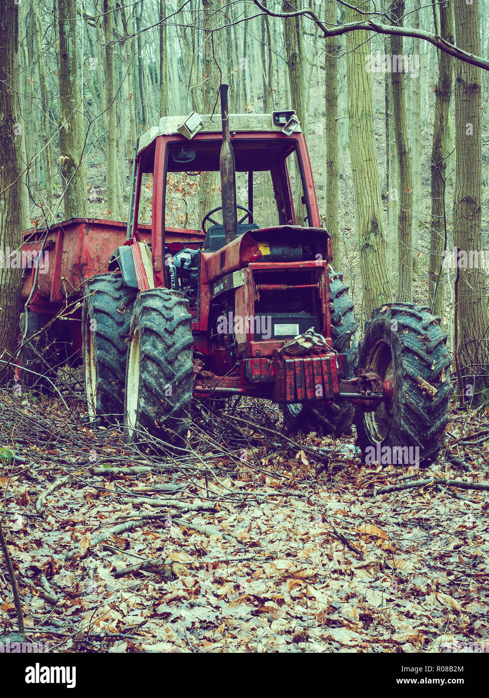 Tractor, abandoned in the forest, operating pollution Stock Photo - Alamy