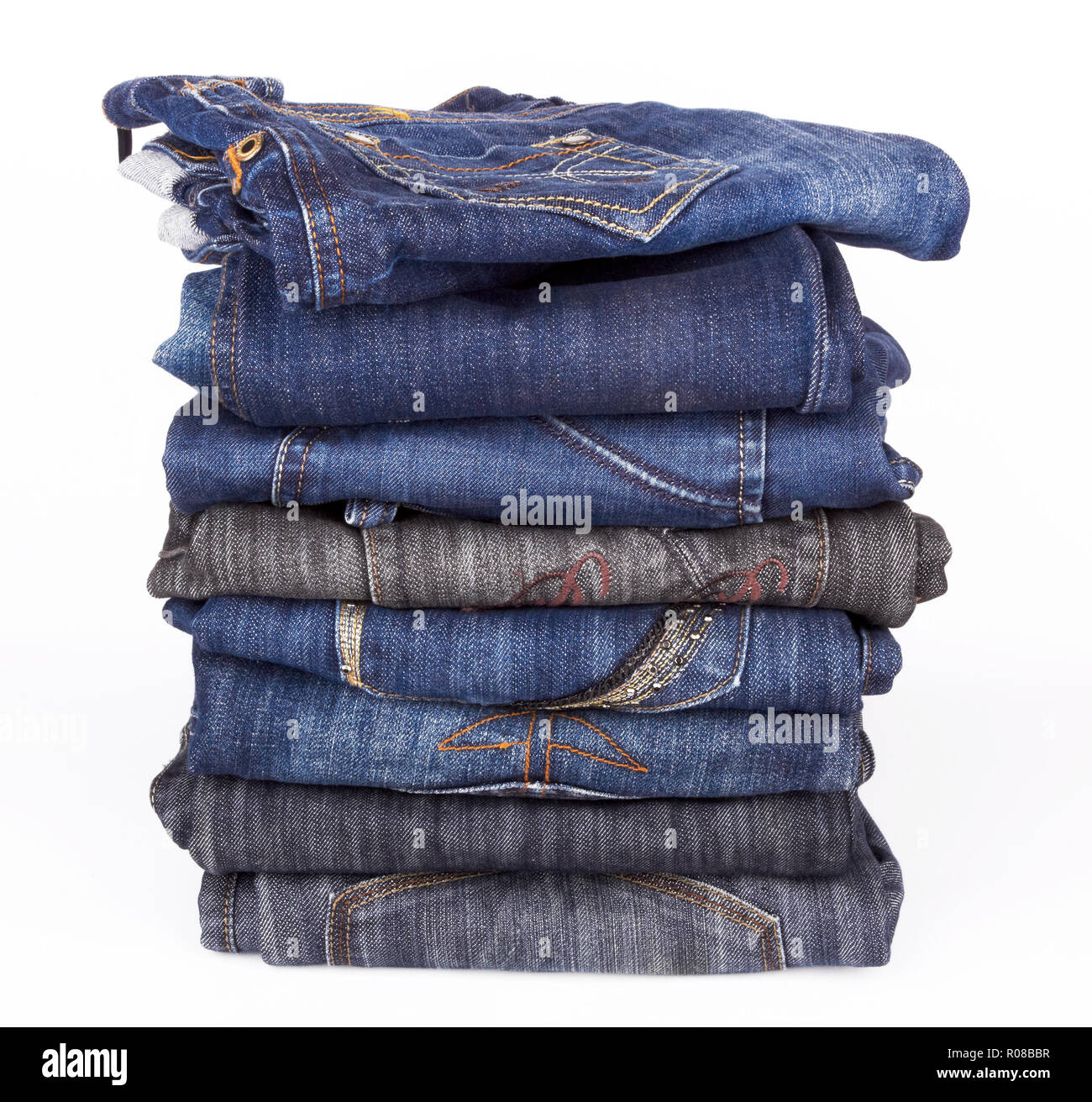Lot of different jeans close-up isolated on white Stock Photo - Alamy