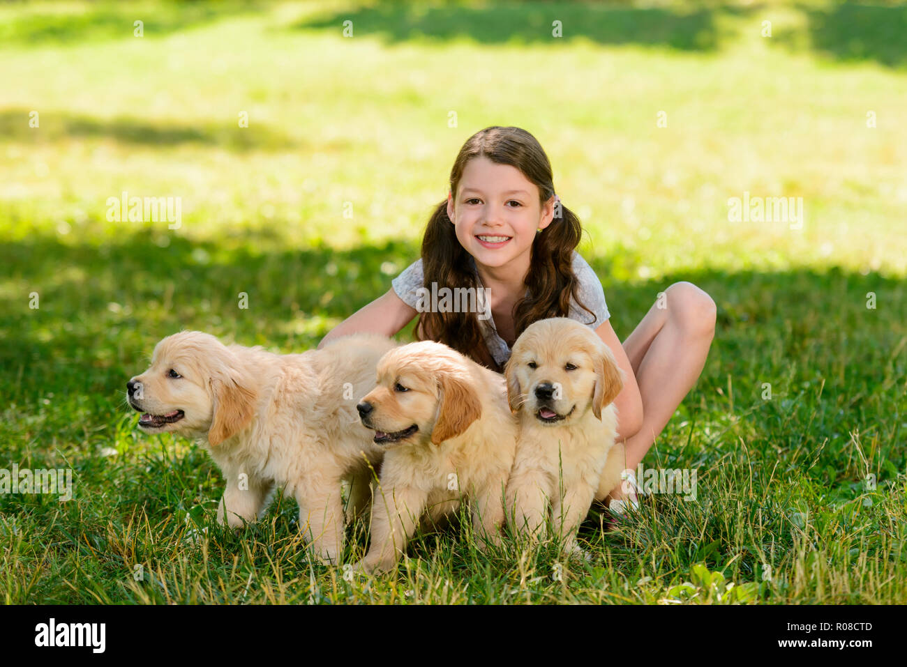 Girl playing puppies hi-res stock photography and images - Alamy
