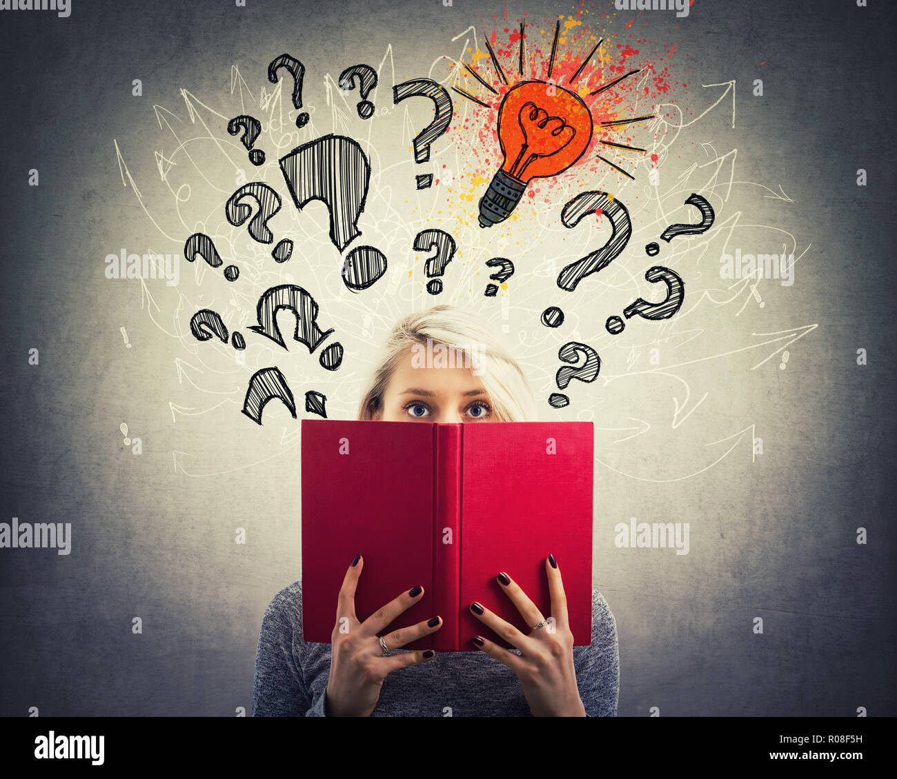 Young pensive woman hiding behind a red book interrogation marks ...