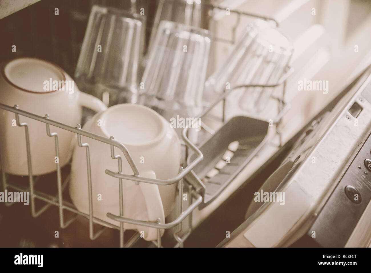 Dishwasher full with clean dishes in kitchen background, copy space ...