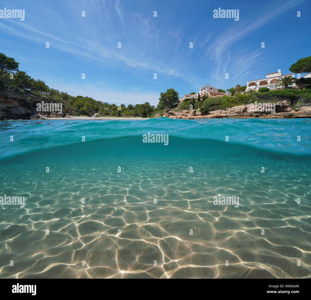 Mediterranean cove with houses and sand underwater sea, split view half ...