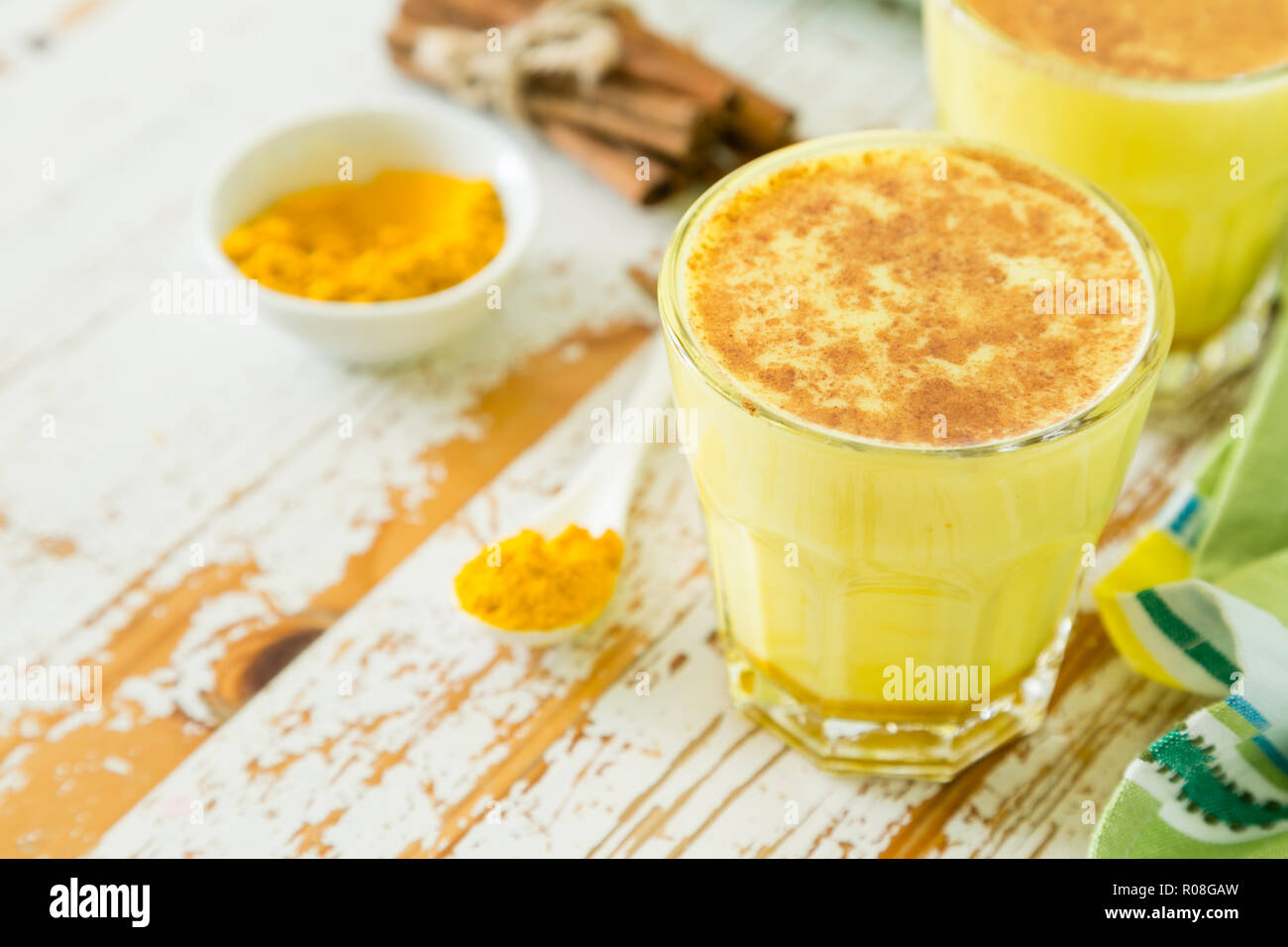 Turmeric drink - golden mild, white wood background, copy space Stock ...