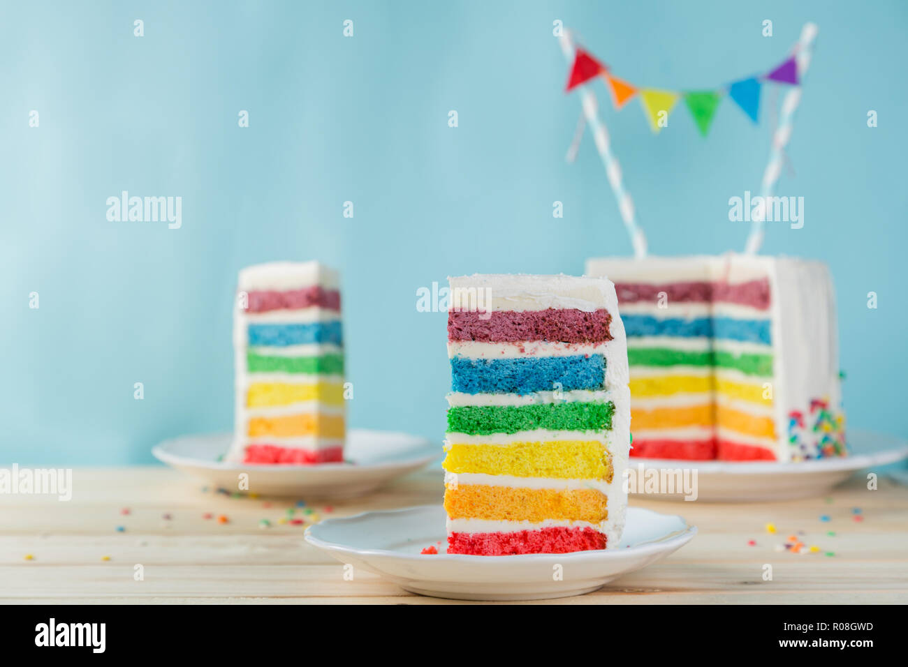 Birthday background - striped rainbow cake with white frosting ...
