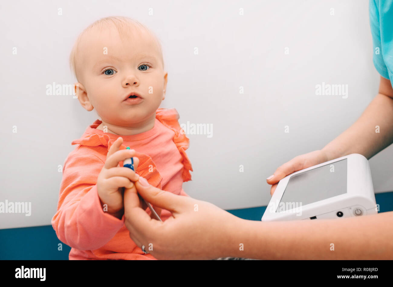 doctor check a baby girl's ears. Little baby having hearing test ...