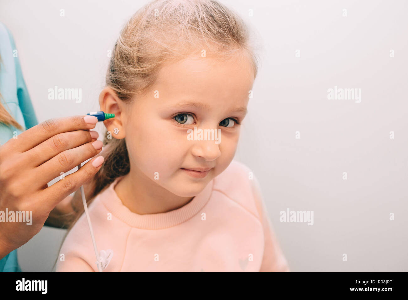 doctor check a girl's ears. Little girl having hearing test , procedure ...