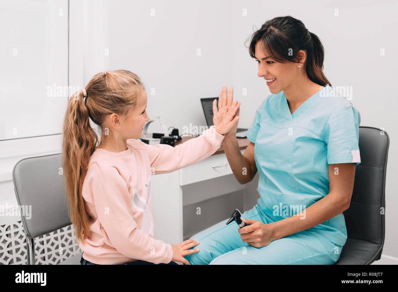 high five doctor with little patient, at medical office. Consultation ...