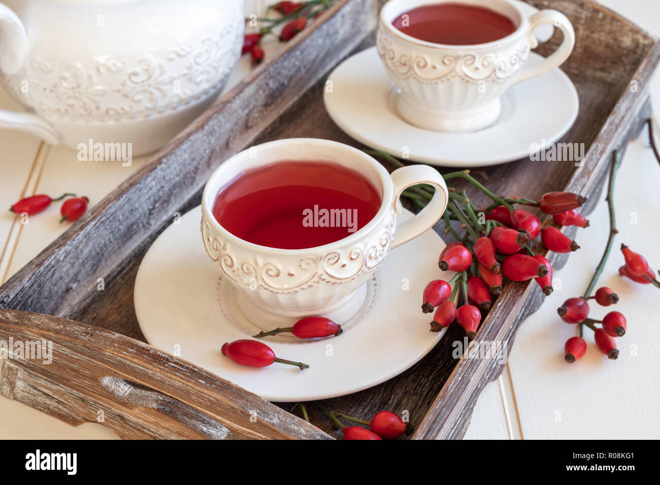 Rose hip tea in white vintage cups Stock Photo - Alamy