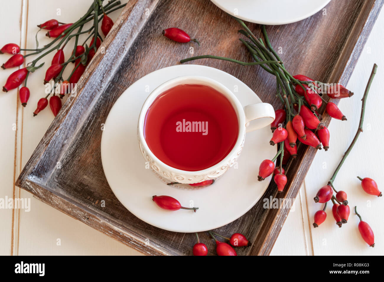 Rose hip tea in a white vintage cup Stock Photo - Alamy