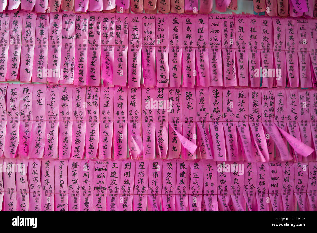 Prayer slip, black Chinese characters on pink tissue paper, in the ...