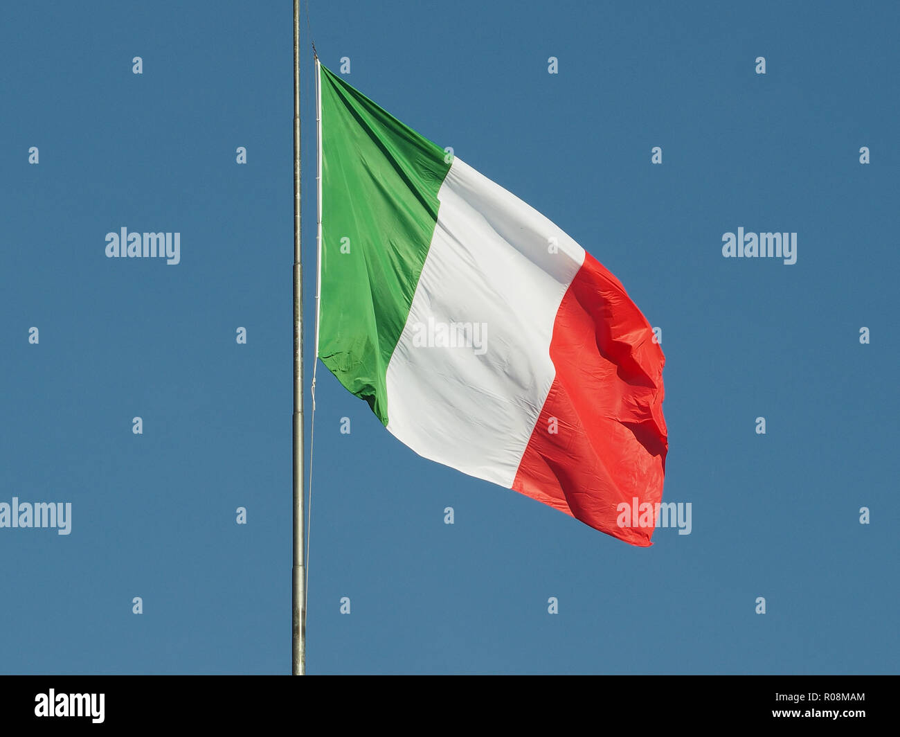 the Italian national flag of Italy, Europe over blue sky Stock Photo ...