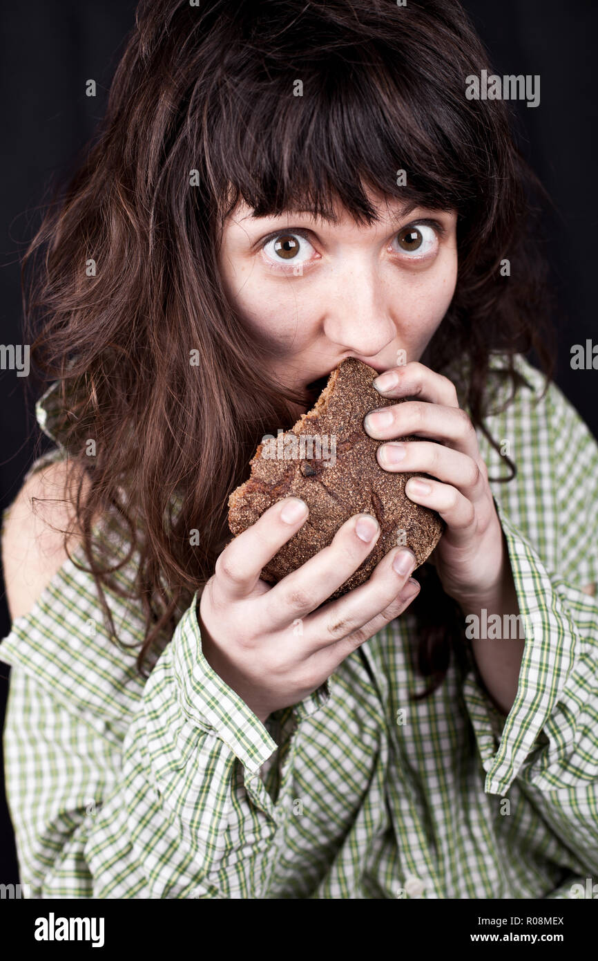Beggar woman eating bread hi-res stock photography and images - Alamy