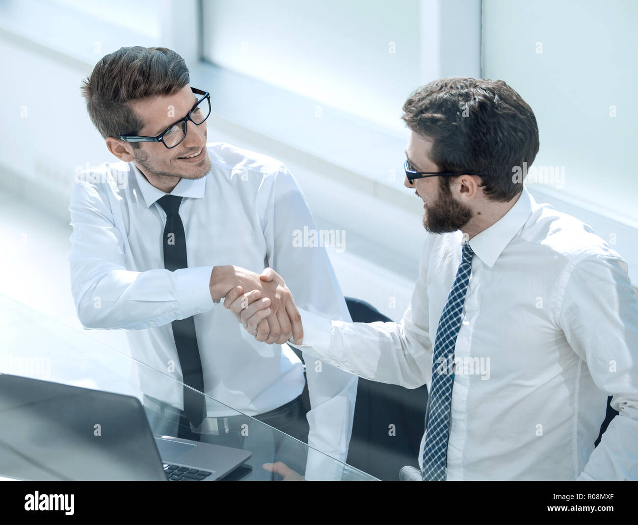close up.employees shaking hands at the Desk.people and technology ...