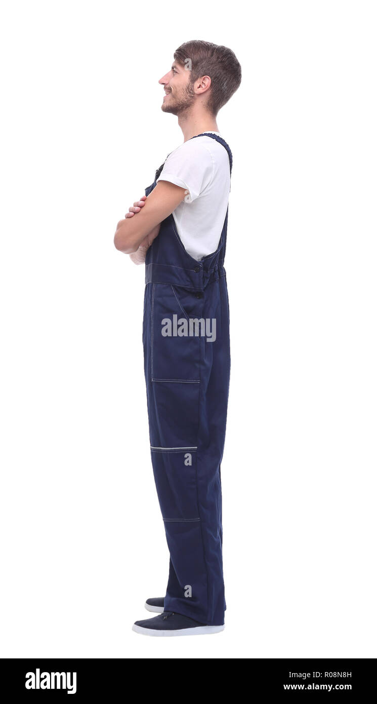 rear view.young man in blue overalls. isolated on white background ...