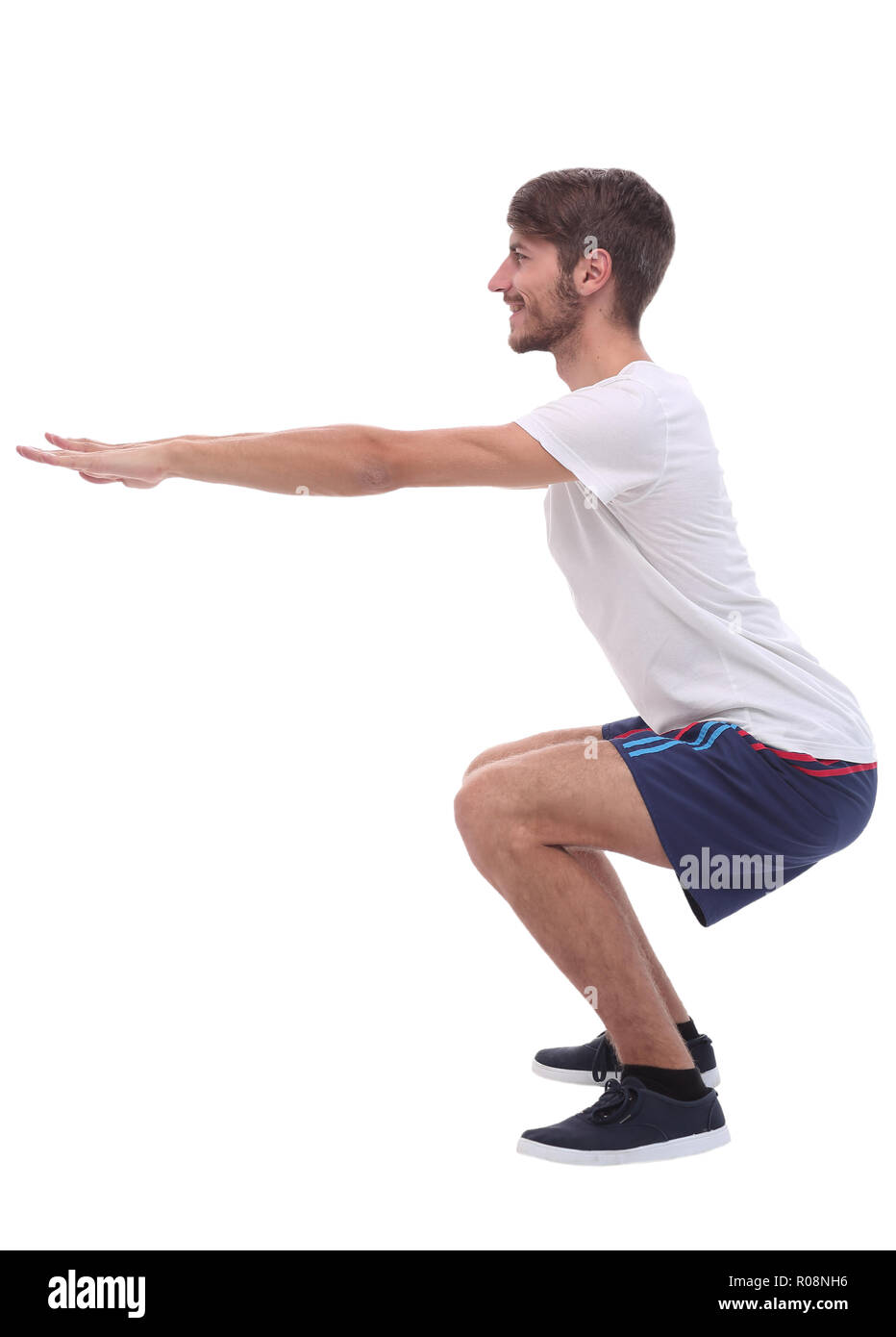 Full length.active male performs squats with straight arms. isolated on ...