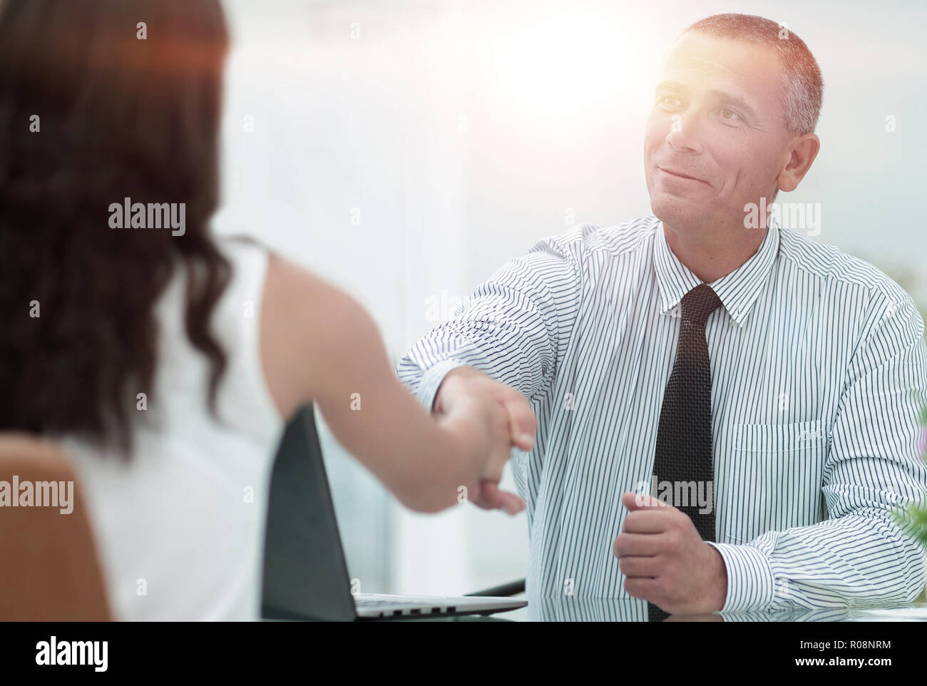 closeup.handshake Manager and client on the background of the office ...