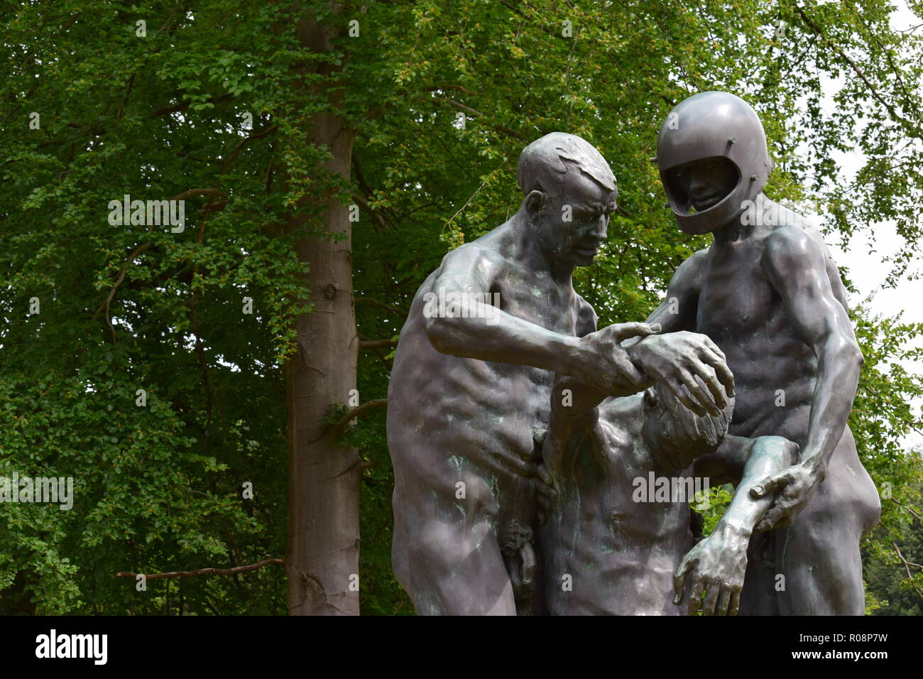 A bronze statue in summer at the War War 2 Cemetery in Reimsbach ...