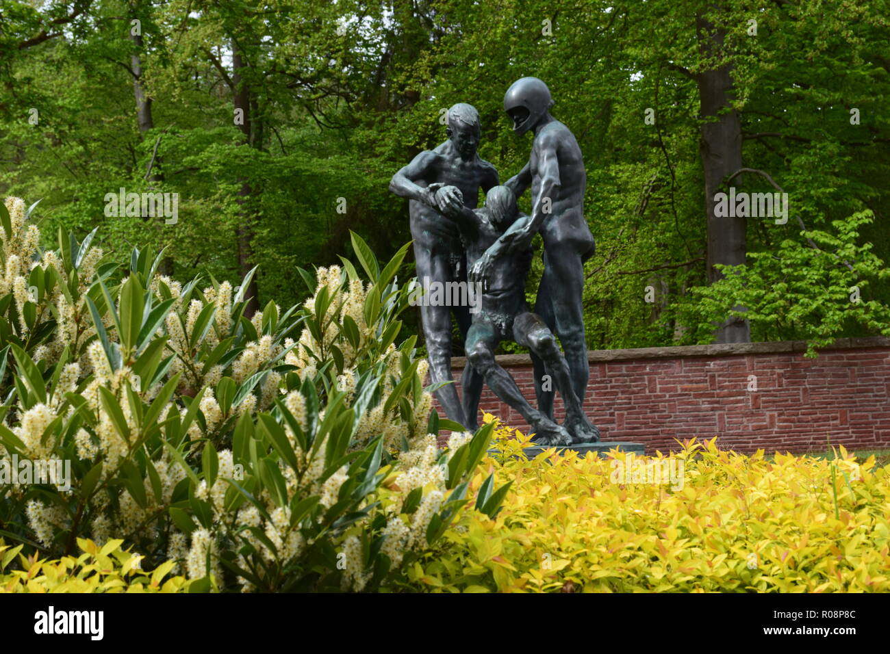 A bronze statue in summer at the War War 2 Cemetery in Reimsbach ...