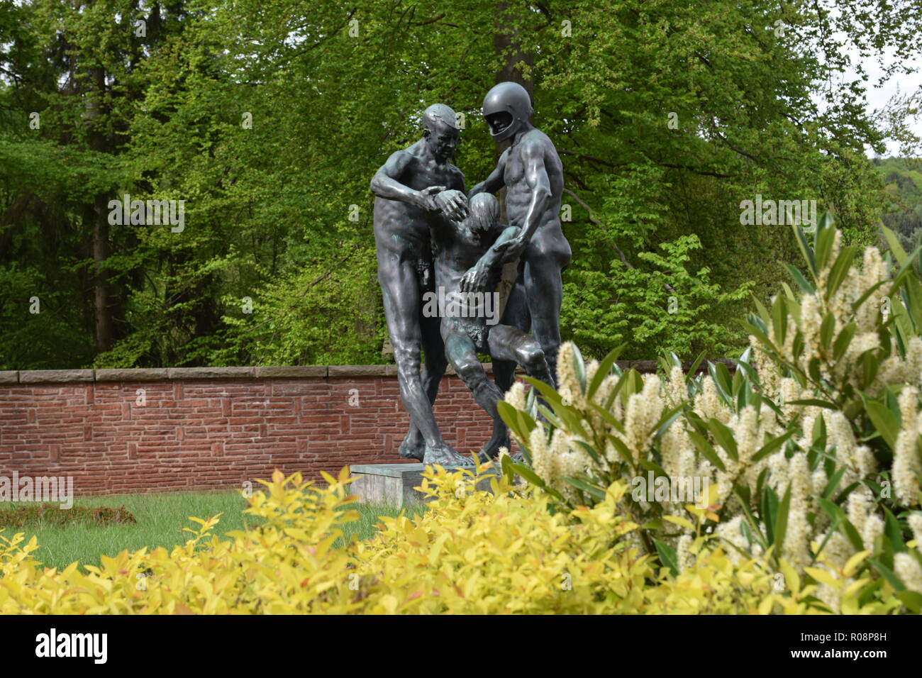 A bronze statue in summer at the War War 2 Cemetery in Reimsbach ...