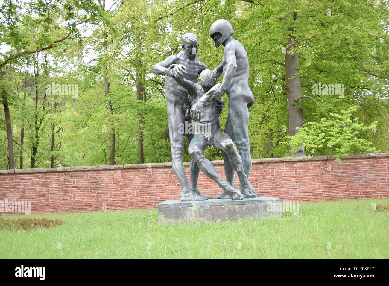 A bronze statue in summer at the War War 2 Cemetery in Reimsbach ...