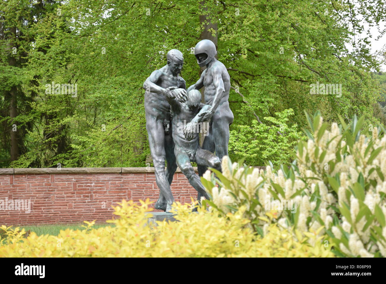 A bronze statue in summer at the War War 2 Cemetery in Reimsbach ...