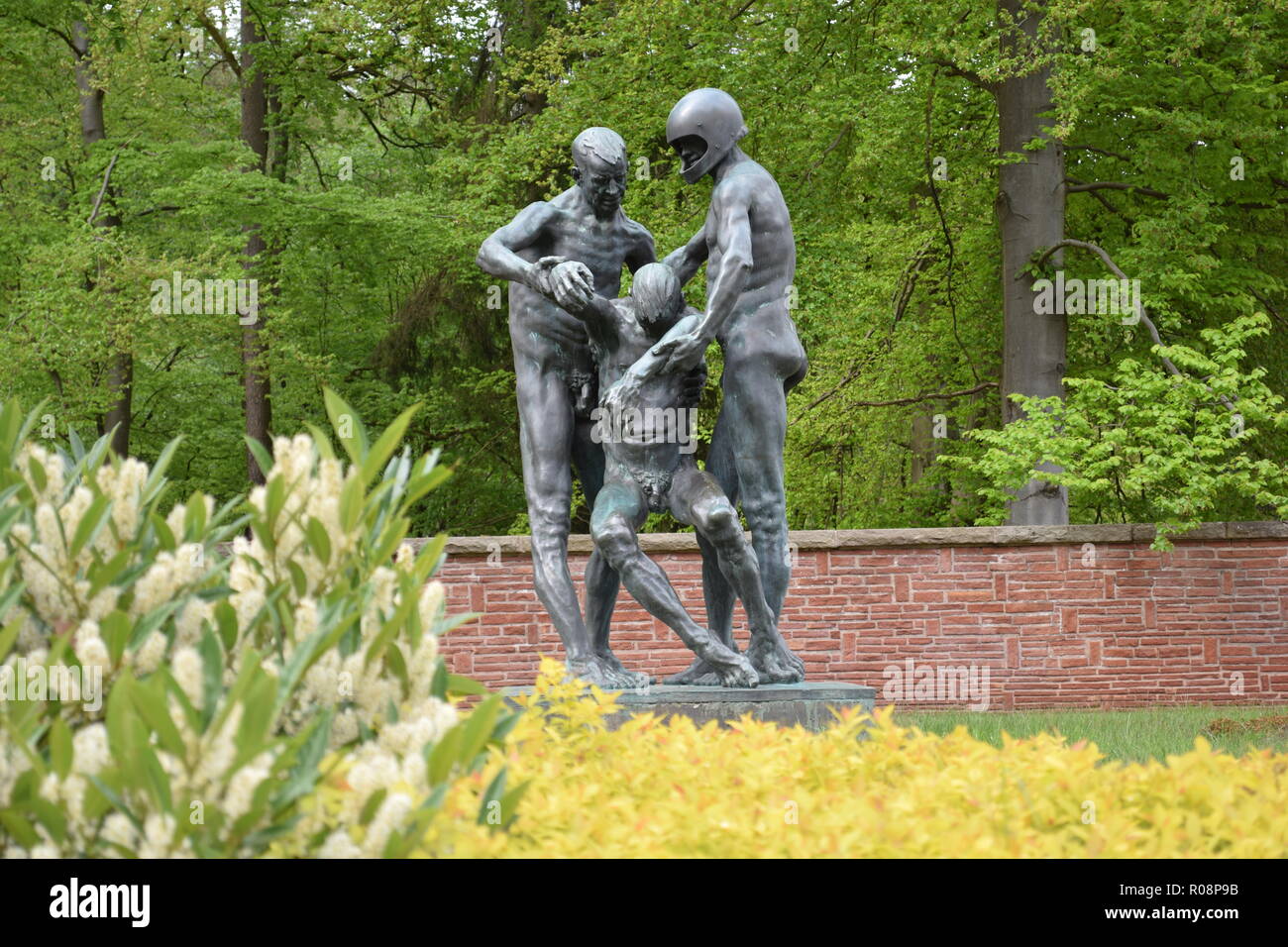 A bronze statue in summer at the War War 2 Cemetery in Reimsbach ...