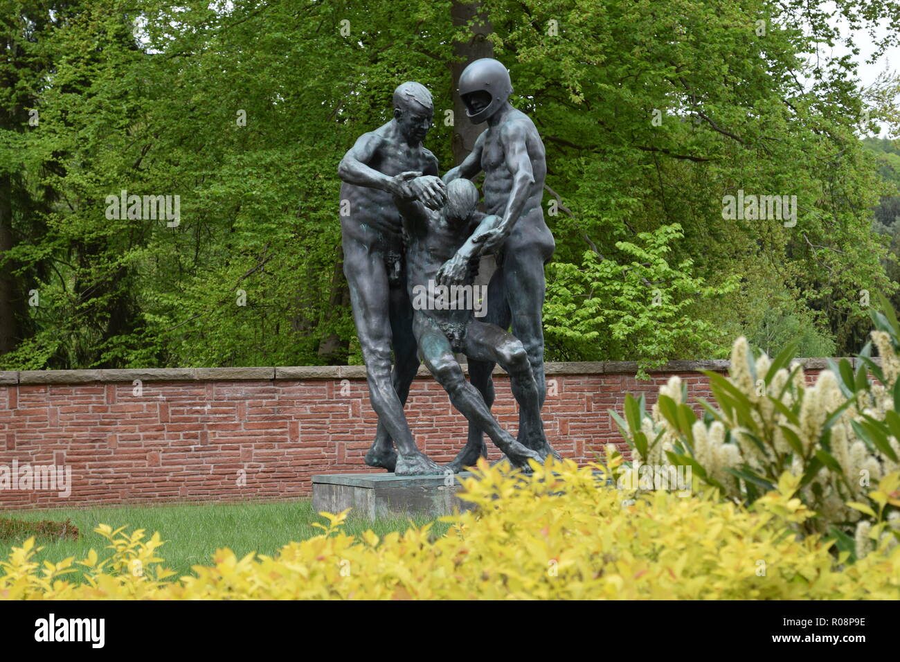 A bronze statue in summer at the War War 2 Cemetery in Reimsbach ...