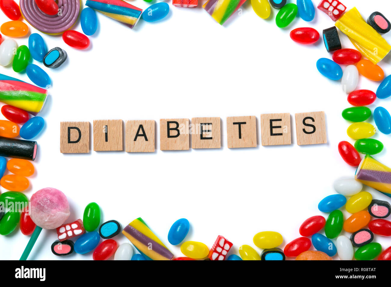Diabetes concept - selection of candy on white background, top view ...