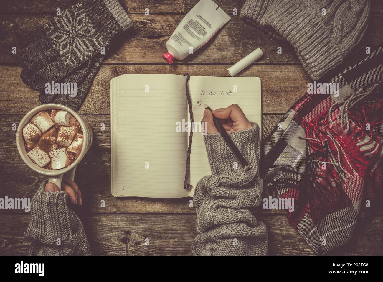 Winter weather survival kit concept. Female hands writing in notebook ...
