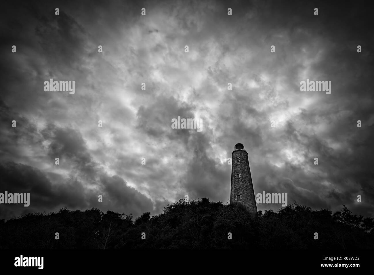 An old Virginia lighthouse watches over the Atlantic ocean on a stormy ...