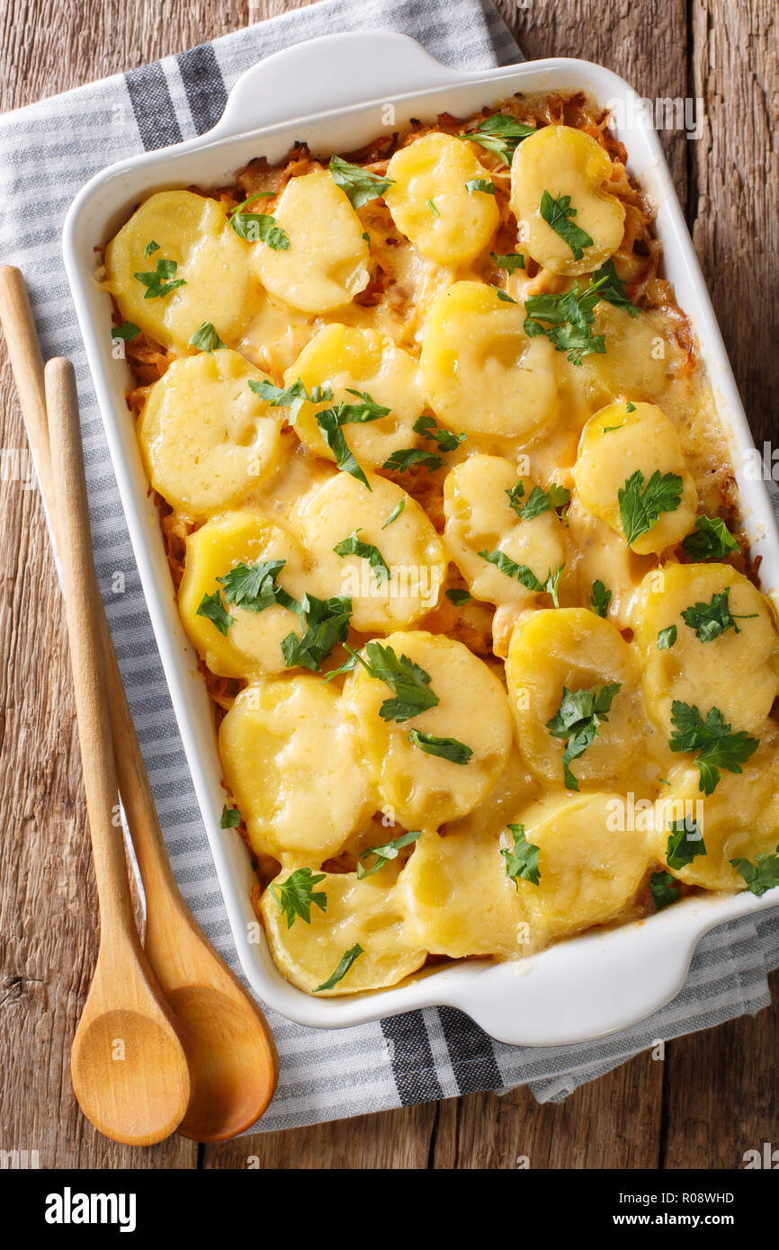 German hot cabbage casserole with potatoes, bacon and cheese close-up ...