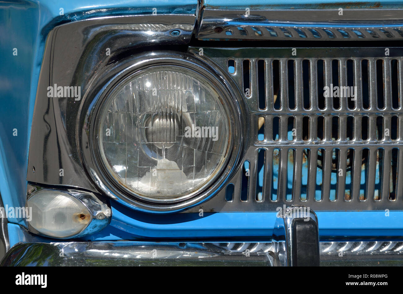 Round headlight on the bus..In the dark, the headlight illuminates the ...