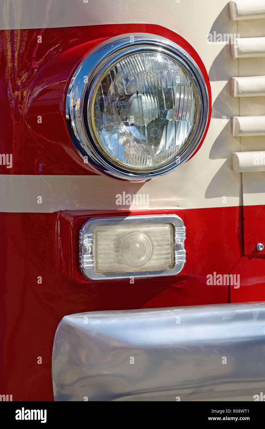 Round headlight on the bus..In the dark, the headlight illuminates the ...