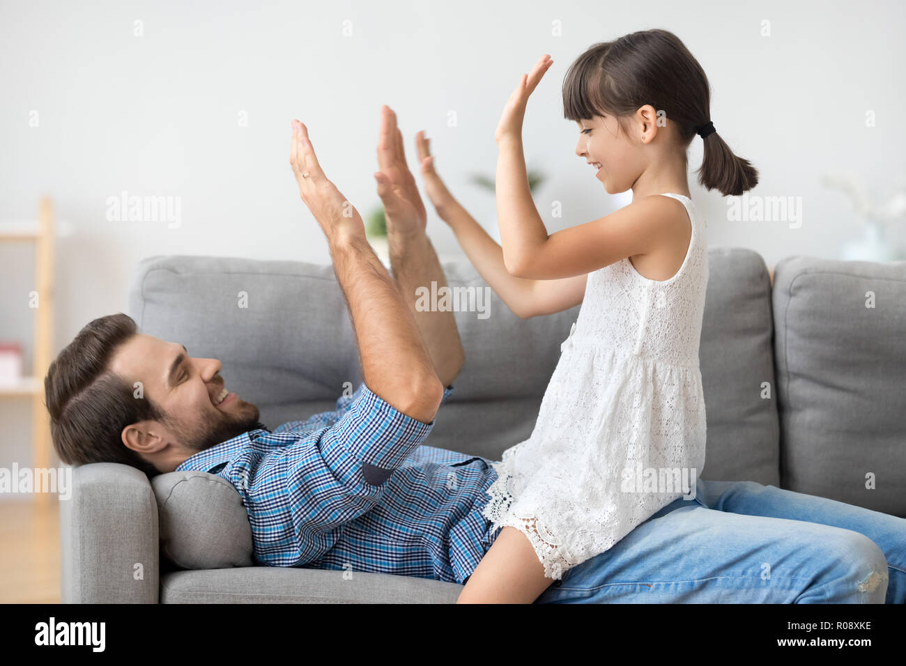 Father and daughter playing clapping hands at home Stock Photo - Alamy