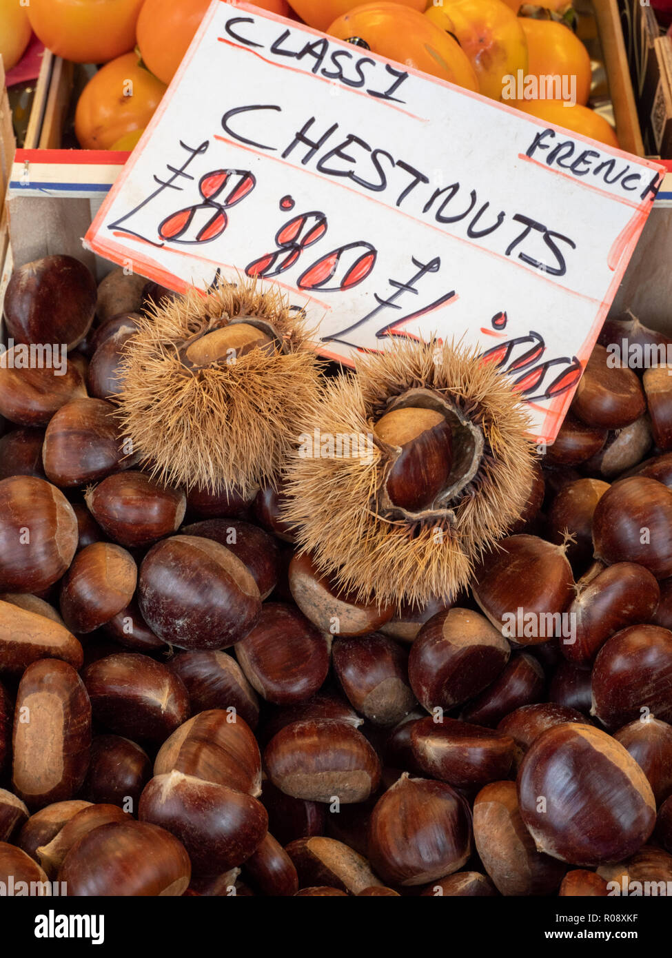 Fresh French sweet chestnuts for sale on a market stall in the UK with ...