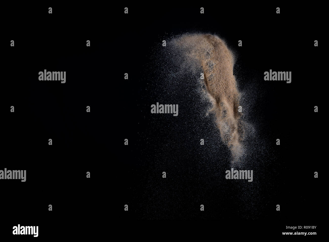 Sandy explosion isolated on black background. Abstract particles cloud ...