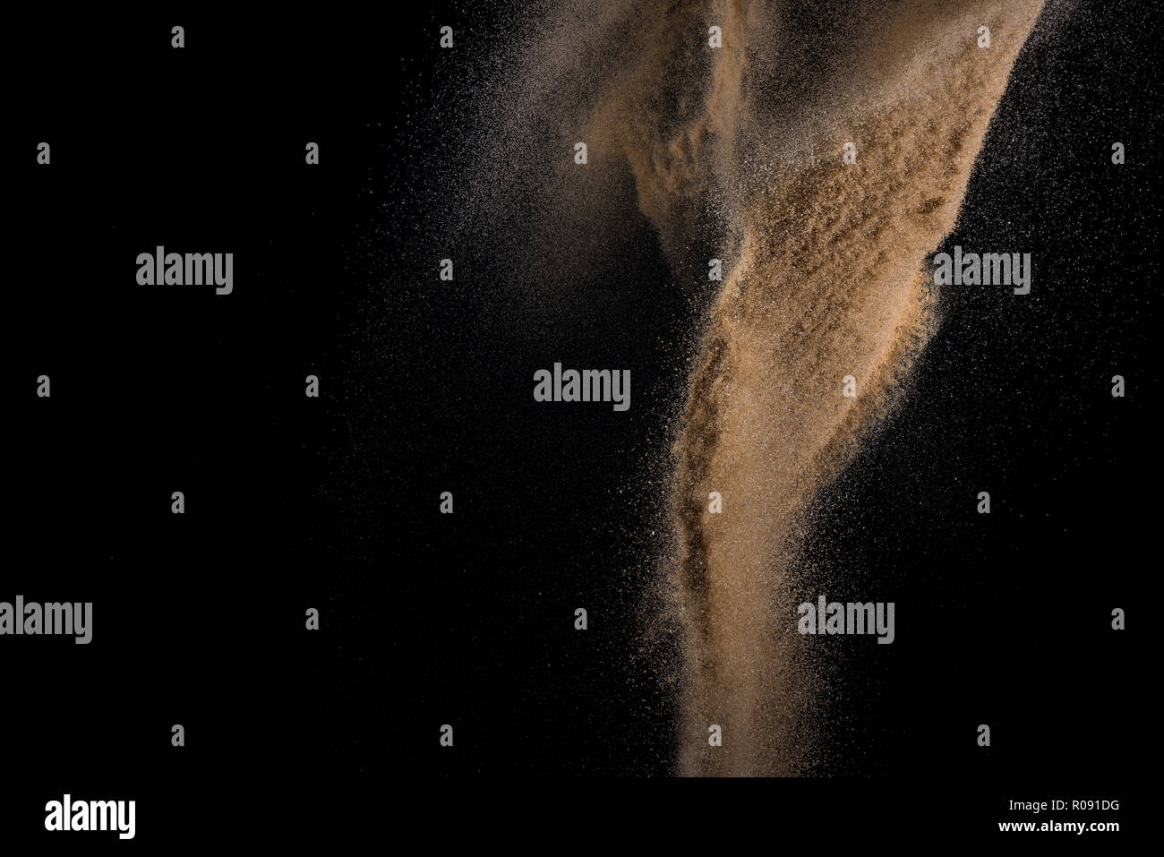 Sandy explosion isolated on black background. Abstract particles cloud ...