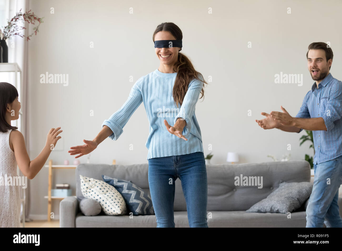 Family playing hide and seek at home Stock Photo - Alamy