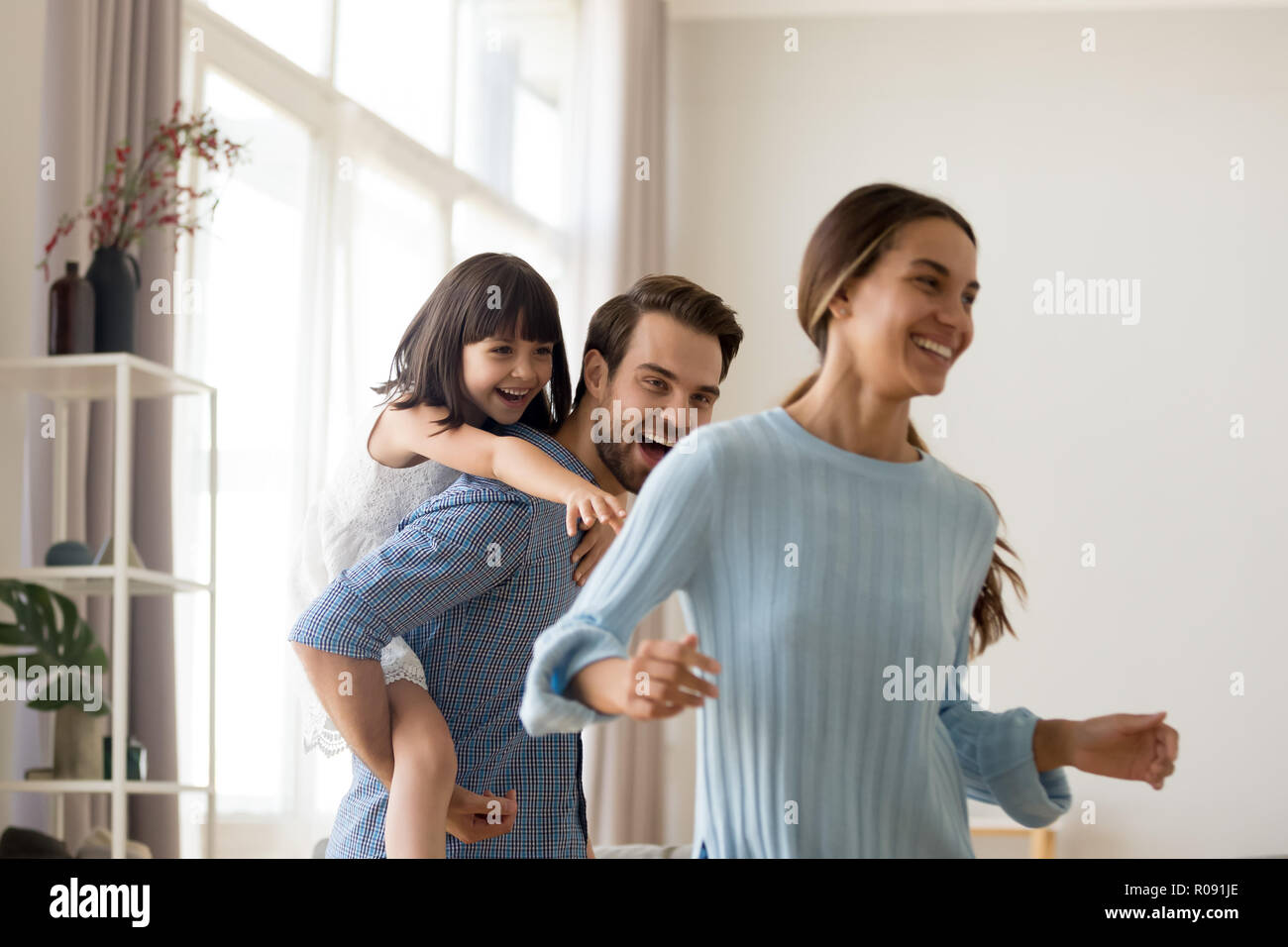 Diverse family playing at home having active weekends Stock Photo - Alamy