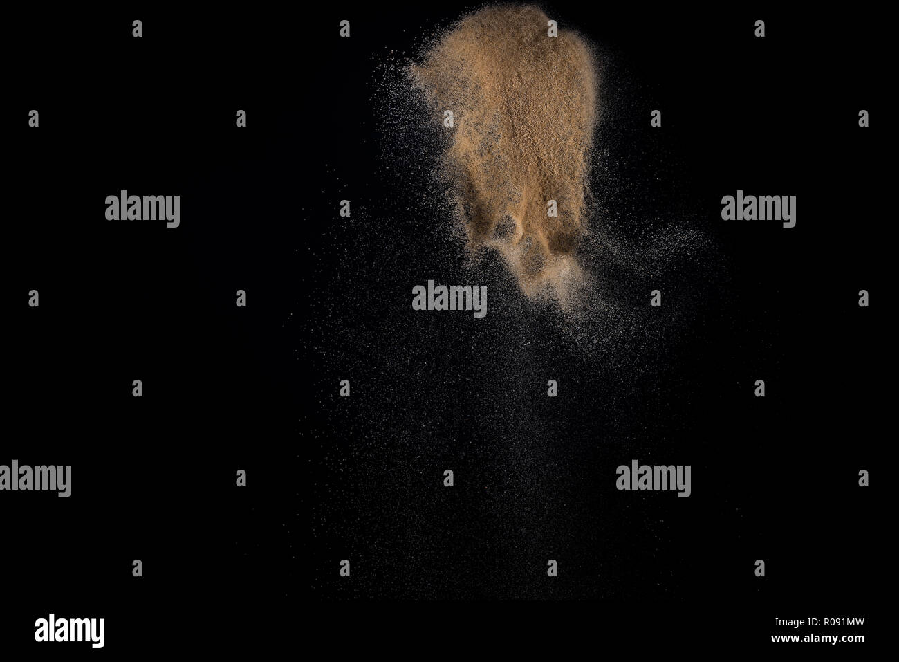 Sandy explosion isolated on black background. Abstract particles cloud ...