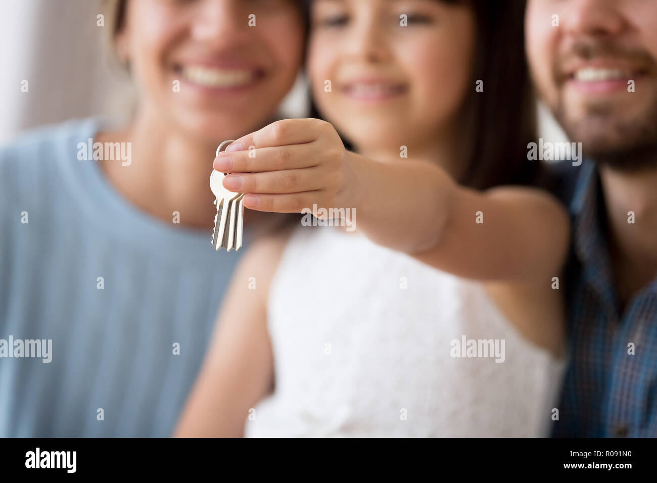 Close up little girl hand holding keys Stock Photo - Alamy