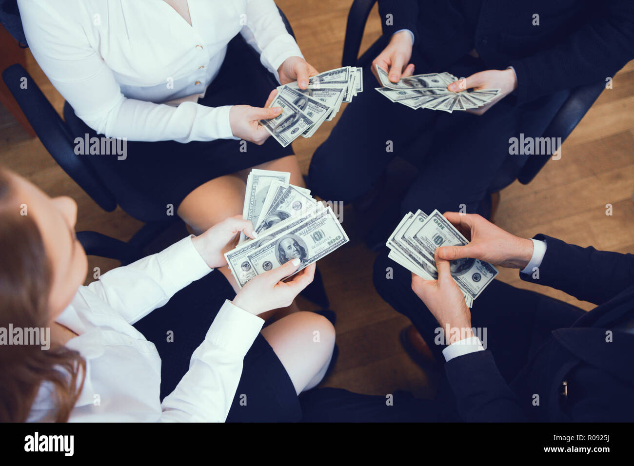 Business Team Counting Money While Sitting In Office At Table. Had ...