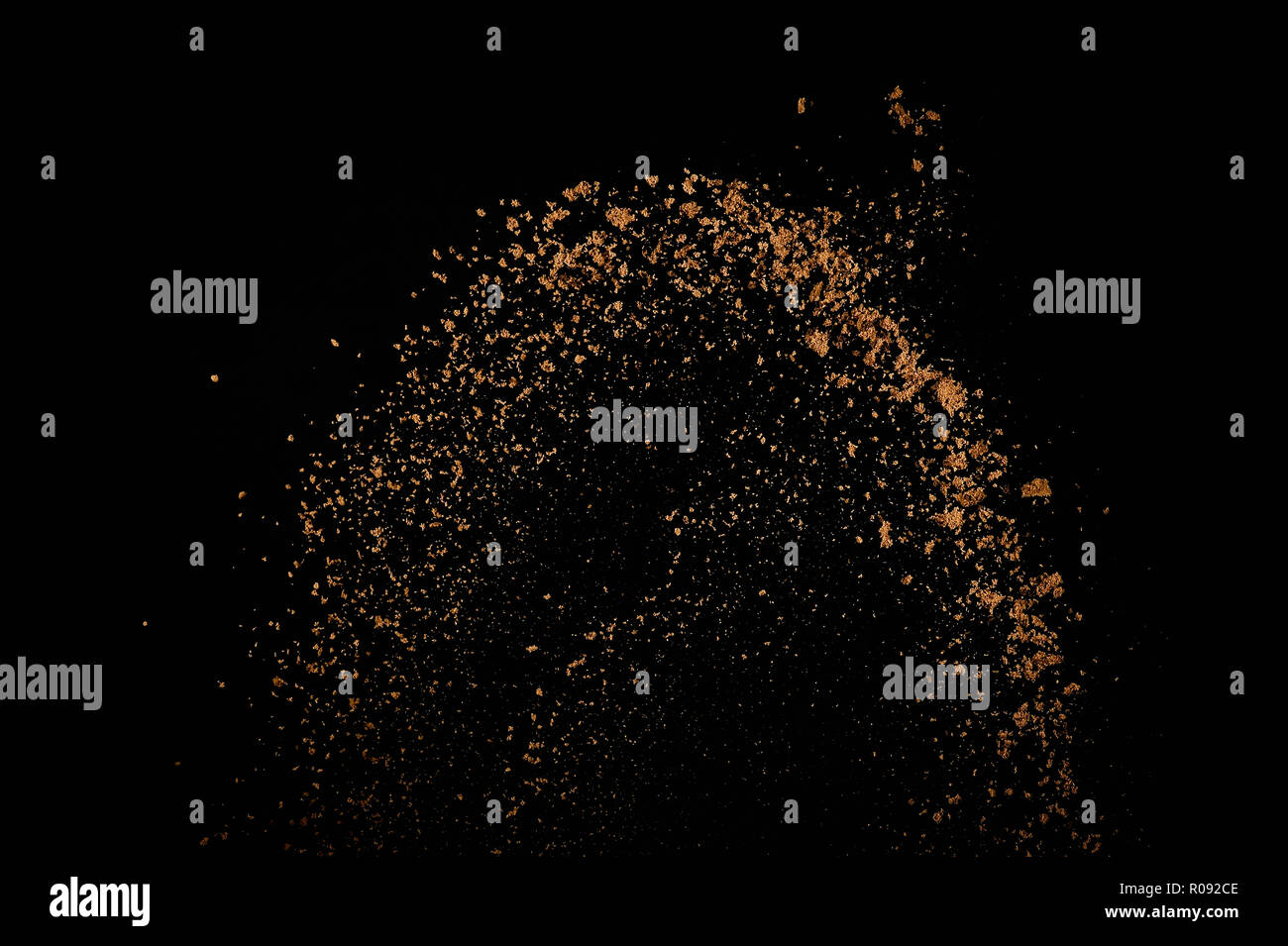 Soil explosion isolated on black background. Abstract cloud of brown ...