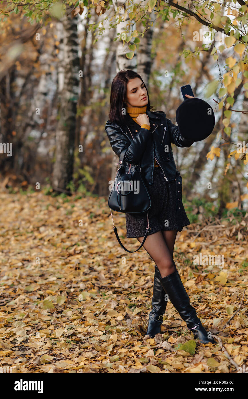 cozy stylish young girl walk at autumn colorful park alone make photos ...