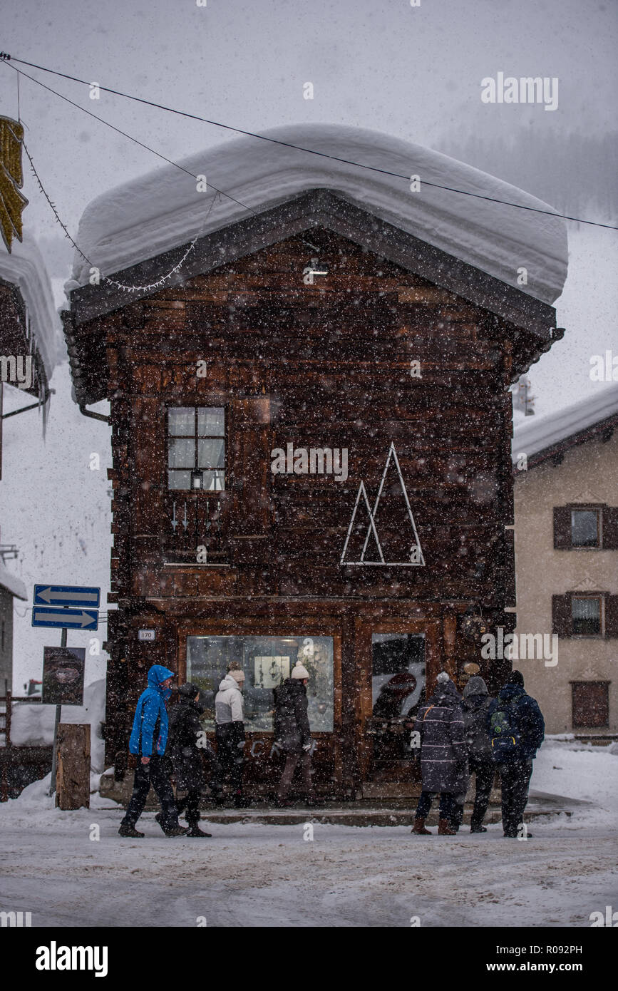 People in ski resort village covered by snow in Europe during winter ...
