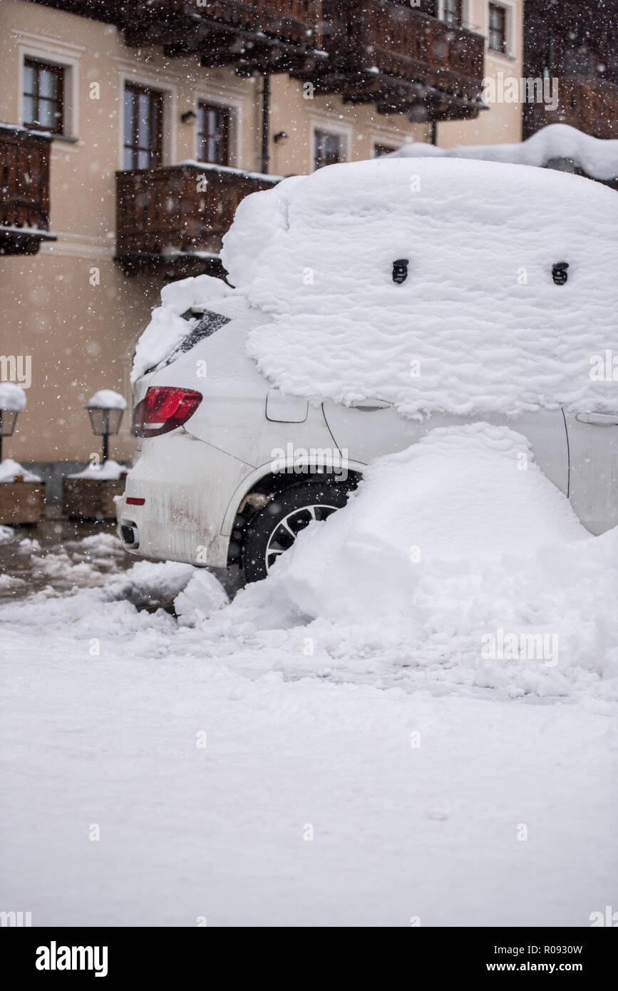 People in ski resort village covered by snow in Europe during winter ...