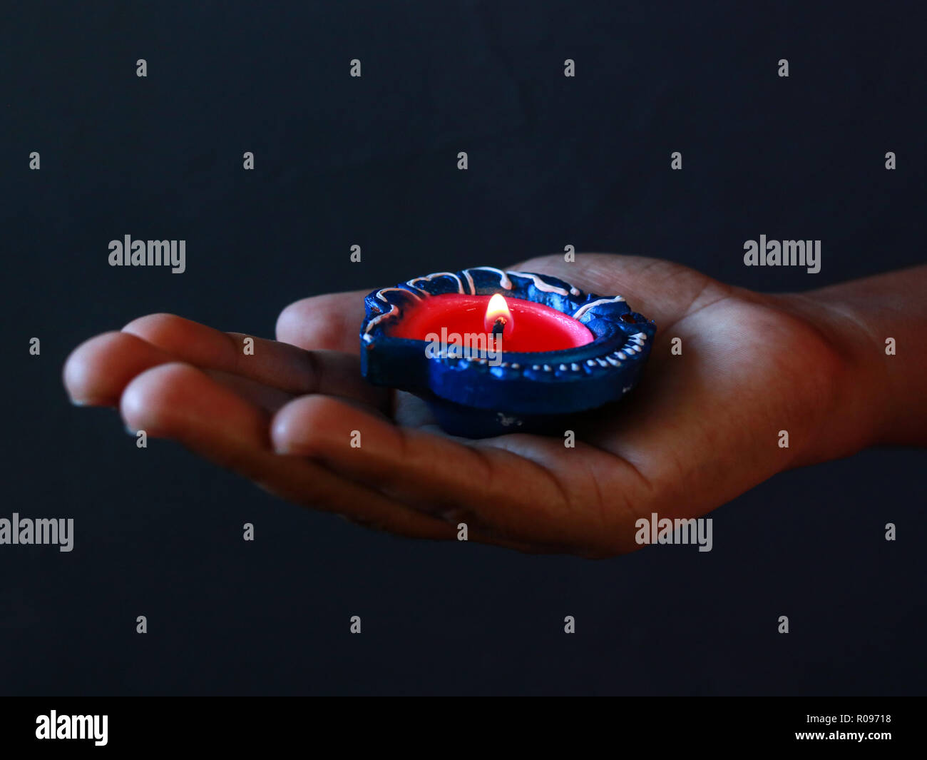 Hand holding diya hi-res stock photography and images - Alamy