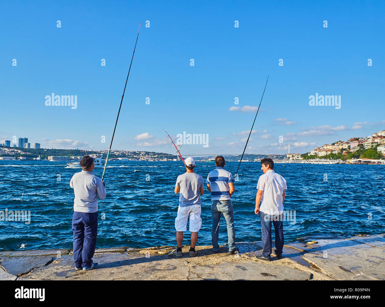 Citizens fishing in the Bosphorus, with The Bosphorus Bridge in the ...