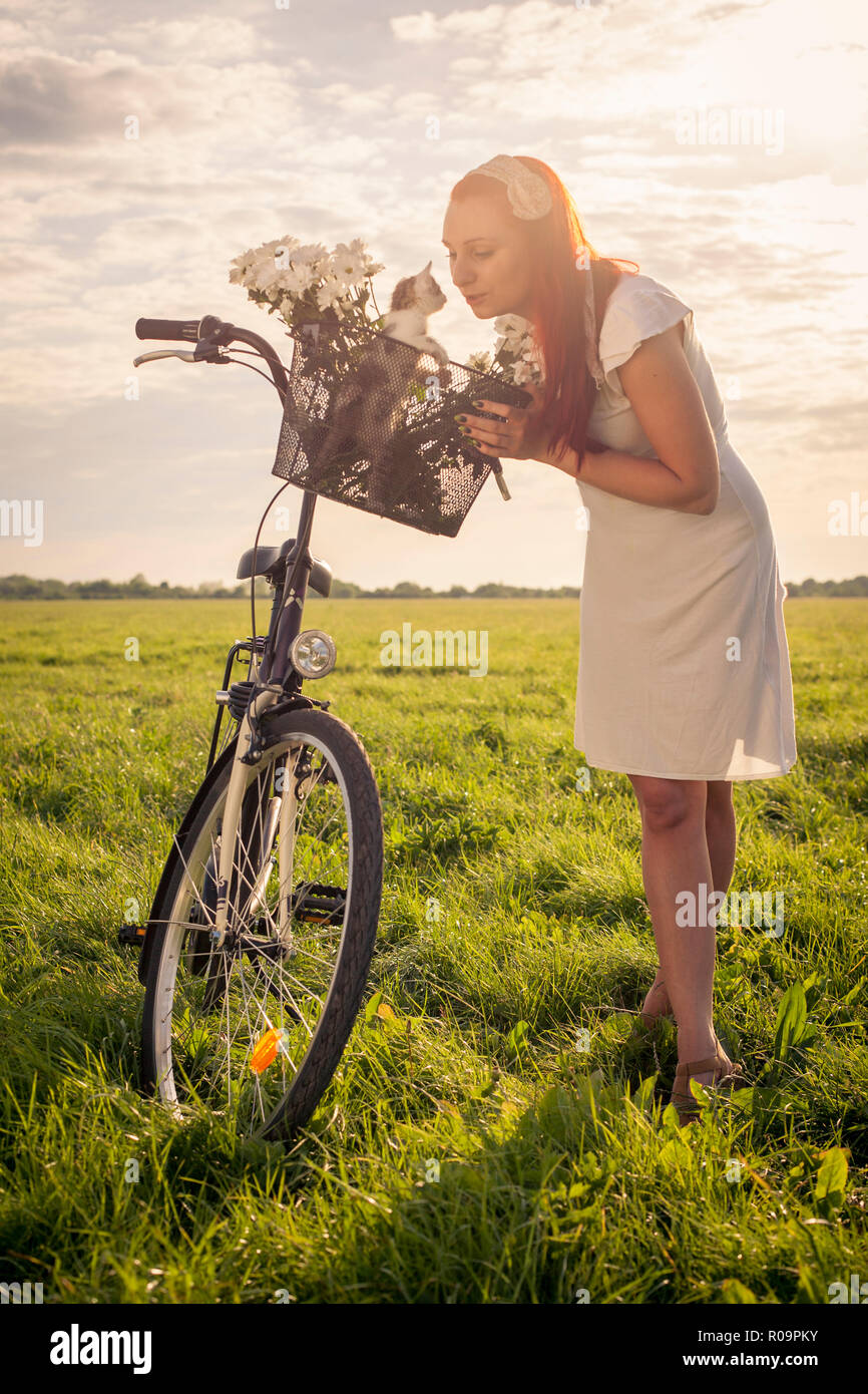Woman with kitten enjoying hot summer day outside Stock Photo - Alamy